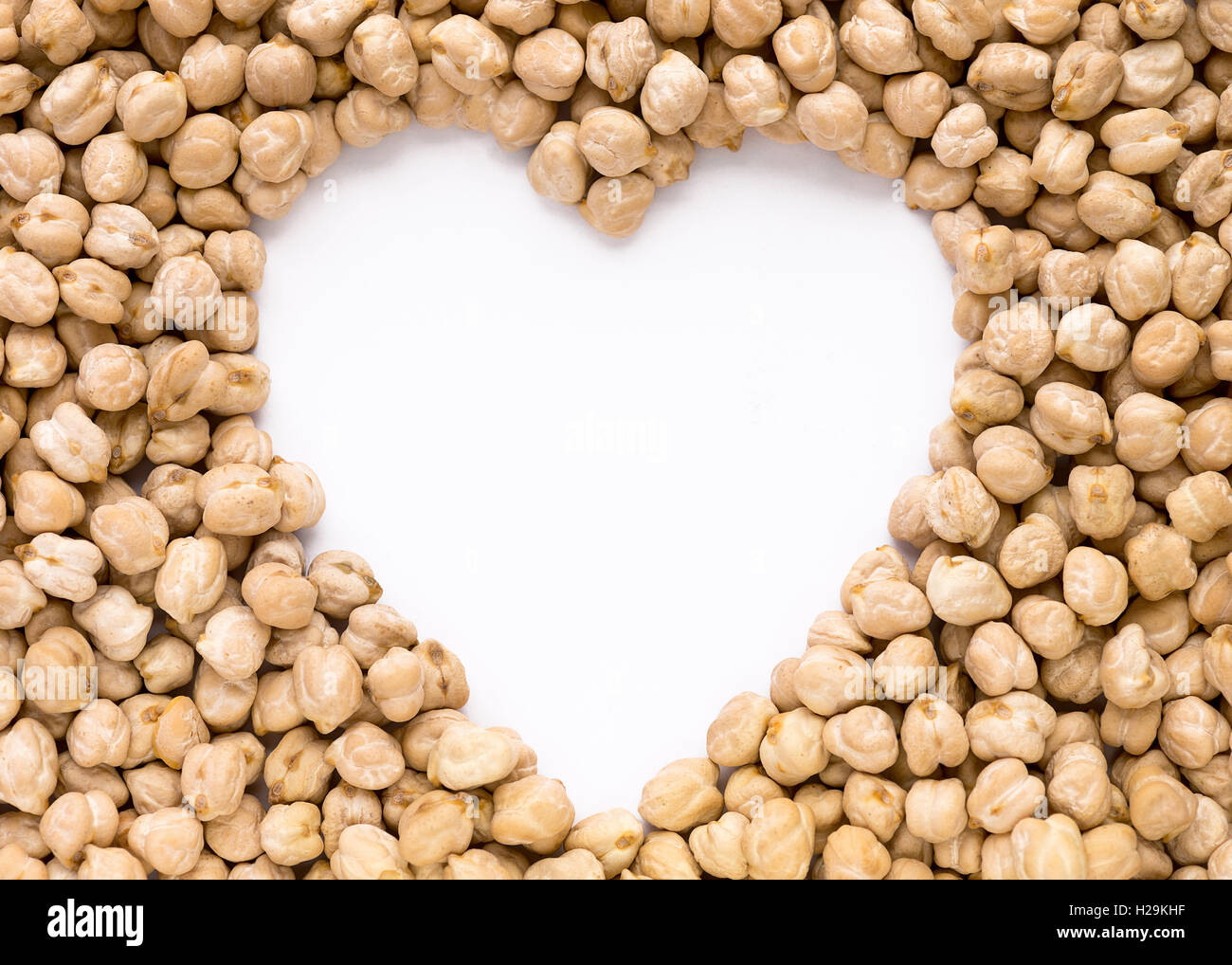 chickpeas showing heart shape in white ,copy space and room for text ...