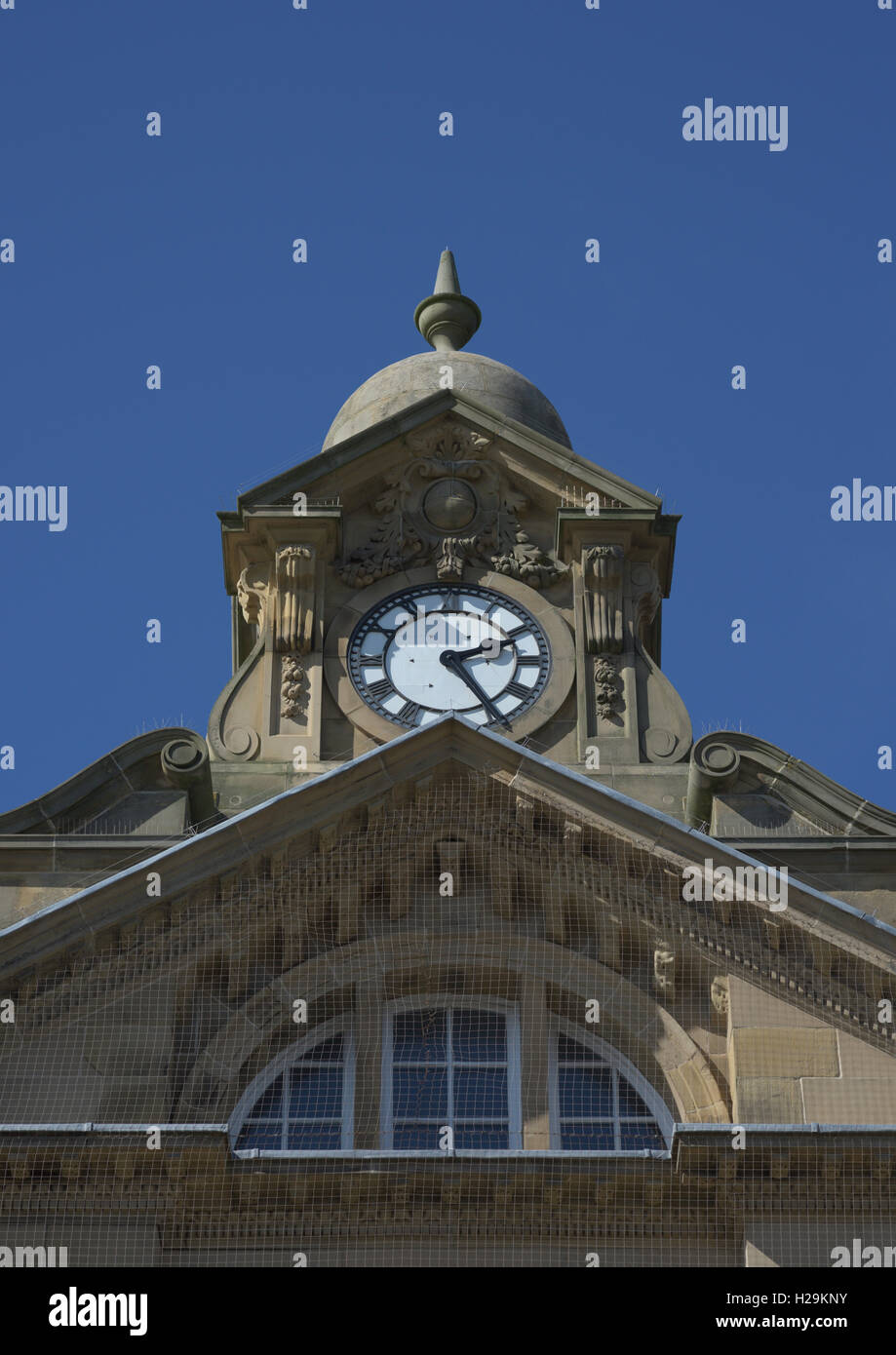 Hsbc bank clock turret and pediment with blue cloudless sky in st annes ...