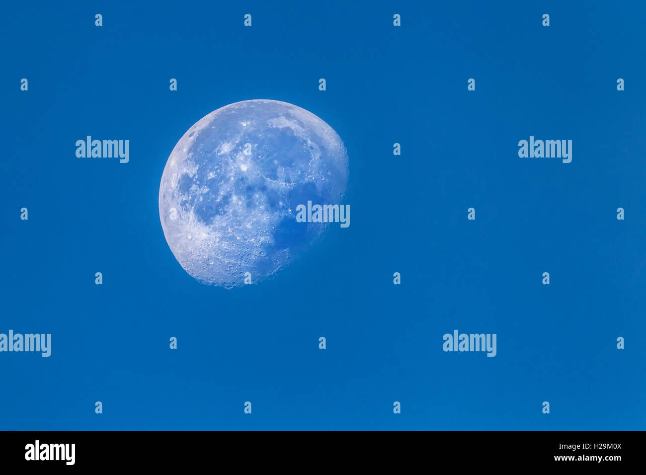 Three Quarter moon in the morning sky Stock Photo - Alamy