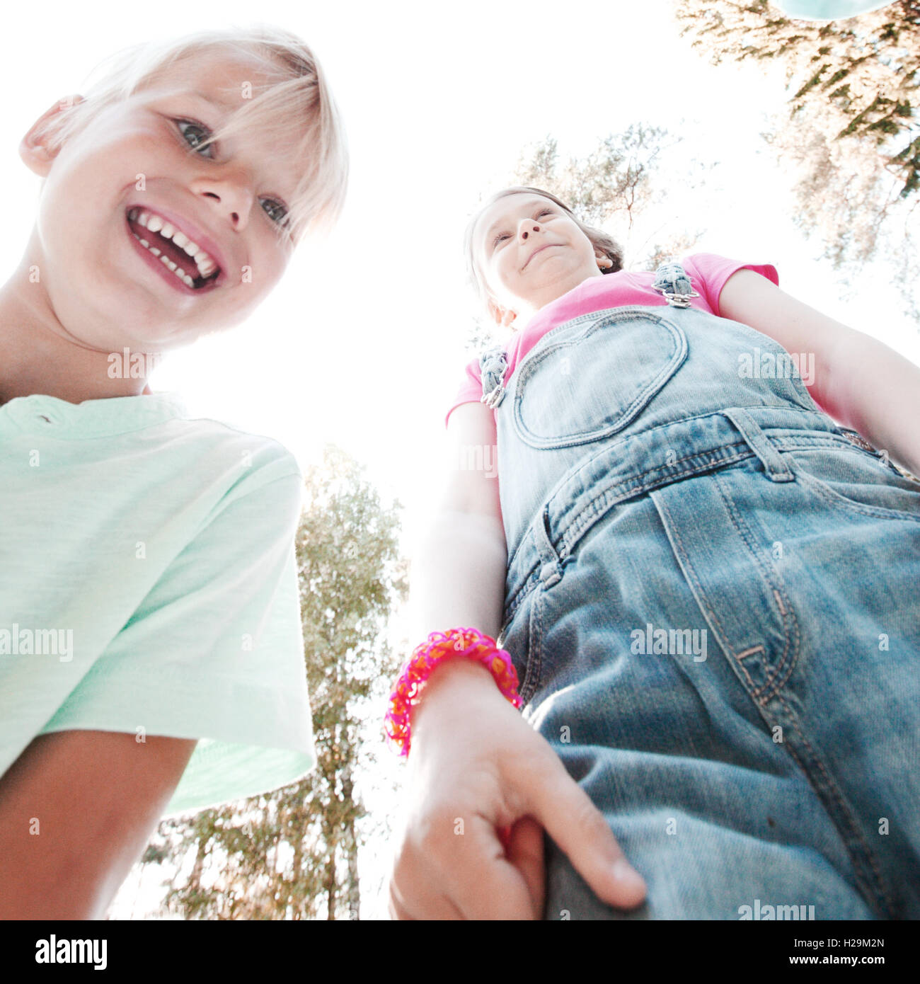 Group of smiling children looking down into camera Stock Photo - Alamy