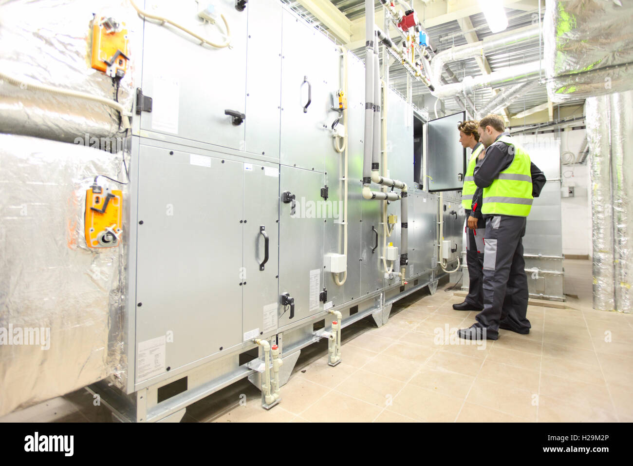 Workers in electrical switchgear room of CNC plant Stock Photo - Alamy