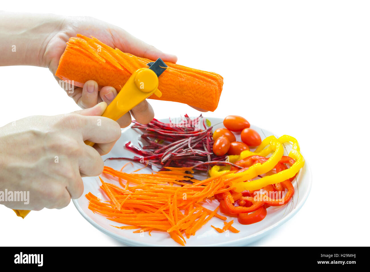 Two hands preparing mixed vegetable on dish isolated on white ...