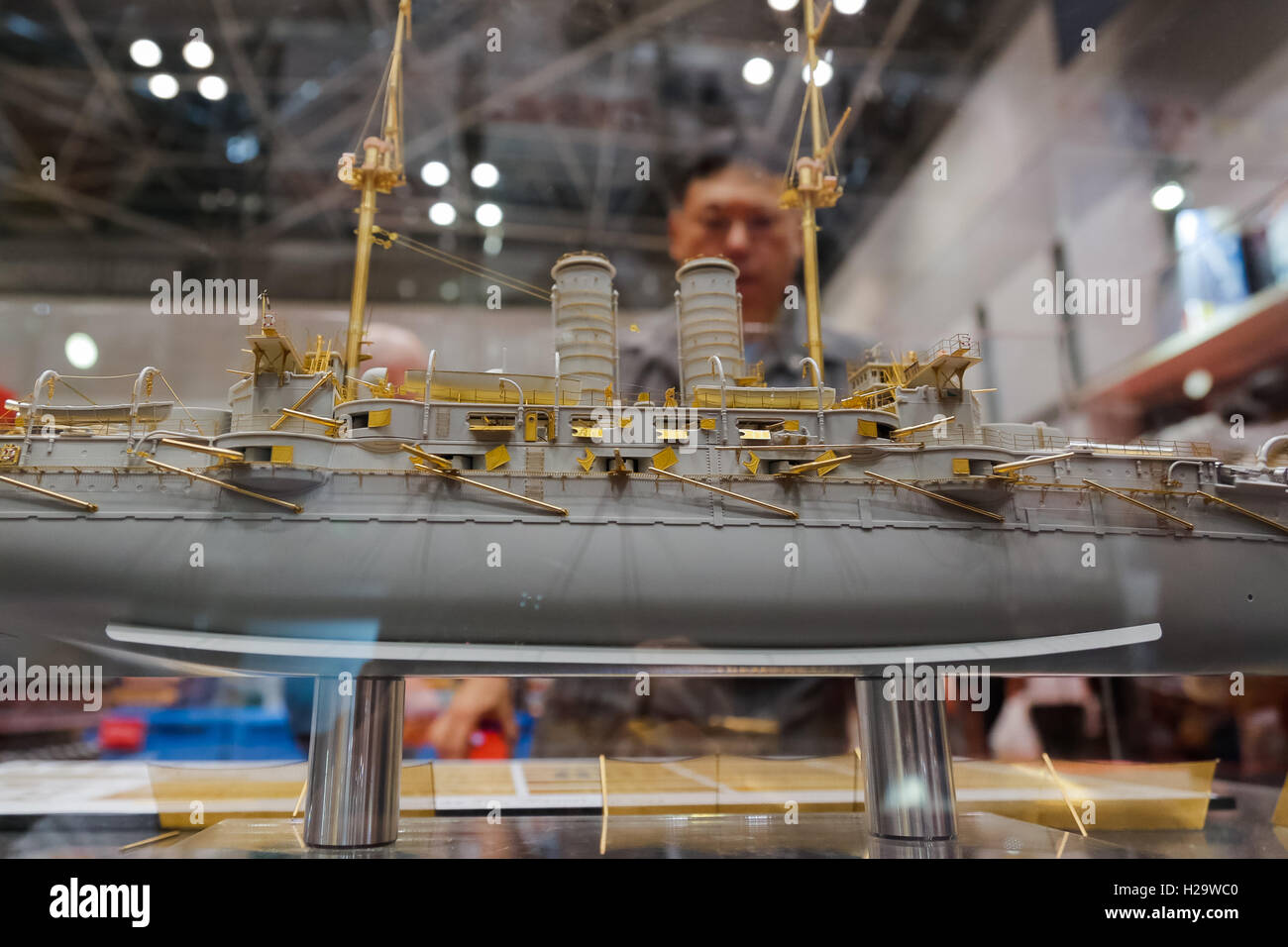 A visitor looks at a replica of the Japanese battleship Mikasa on ...