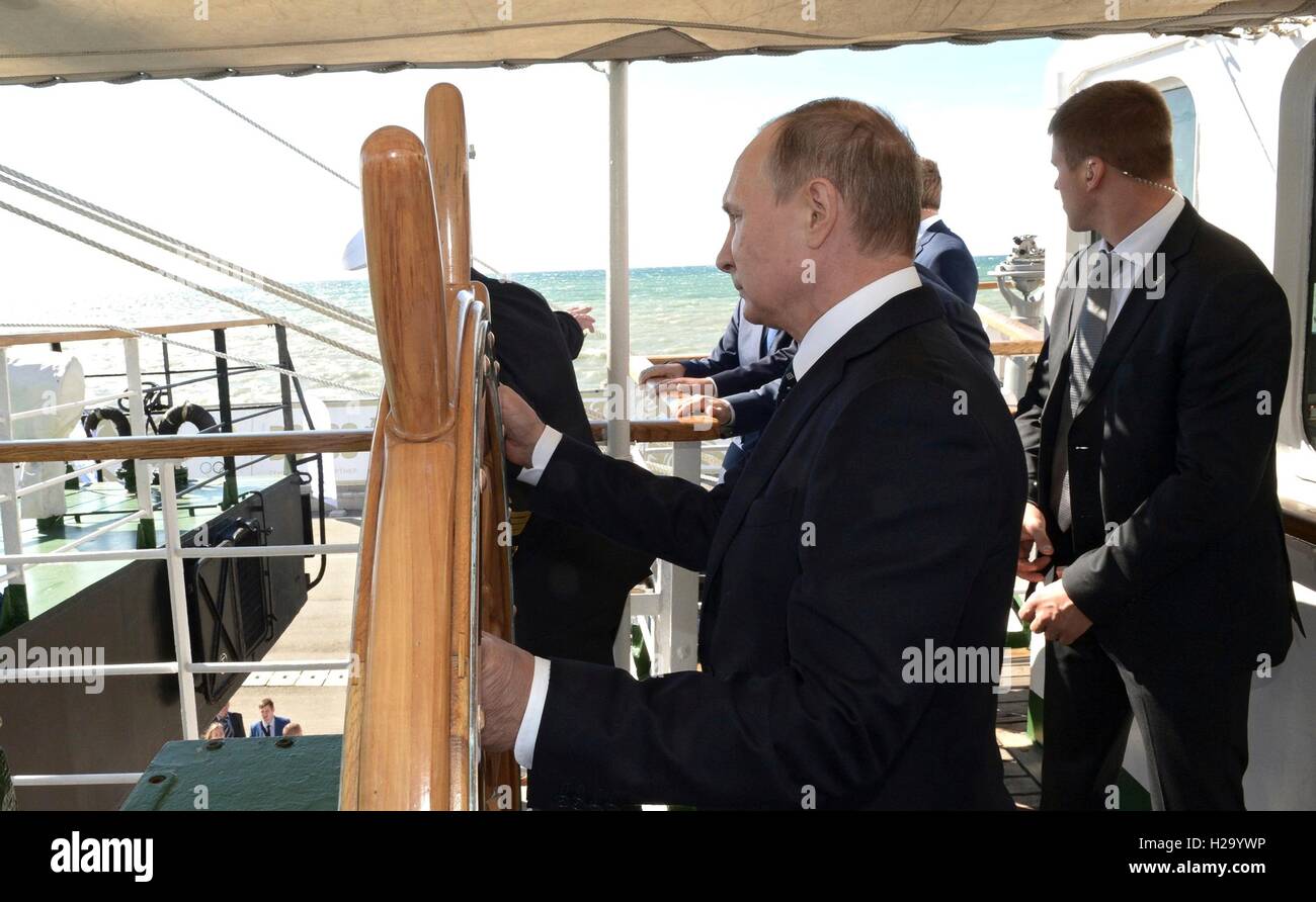 Russian President Vladimir Putin tries his hand at the ships wheel ...