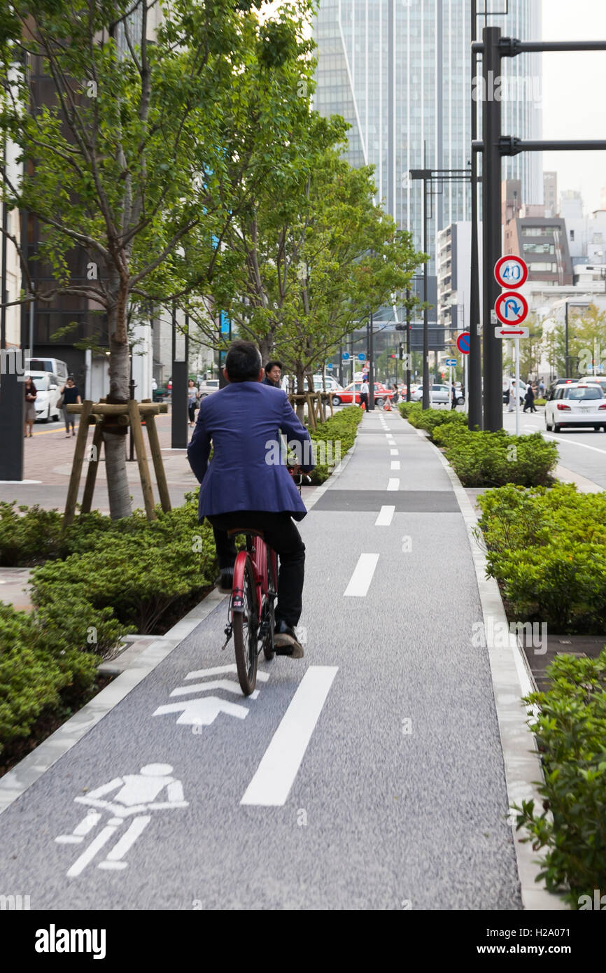A man on a bicycle rides along newly opened section of Loop Road No. 2 ...