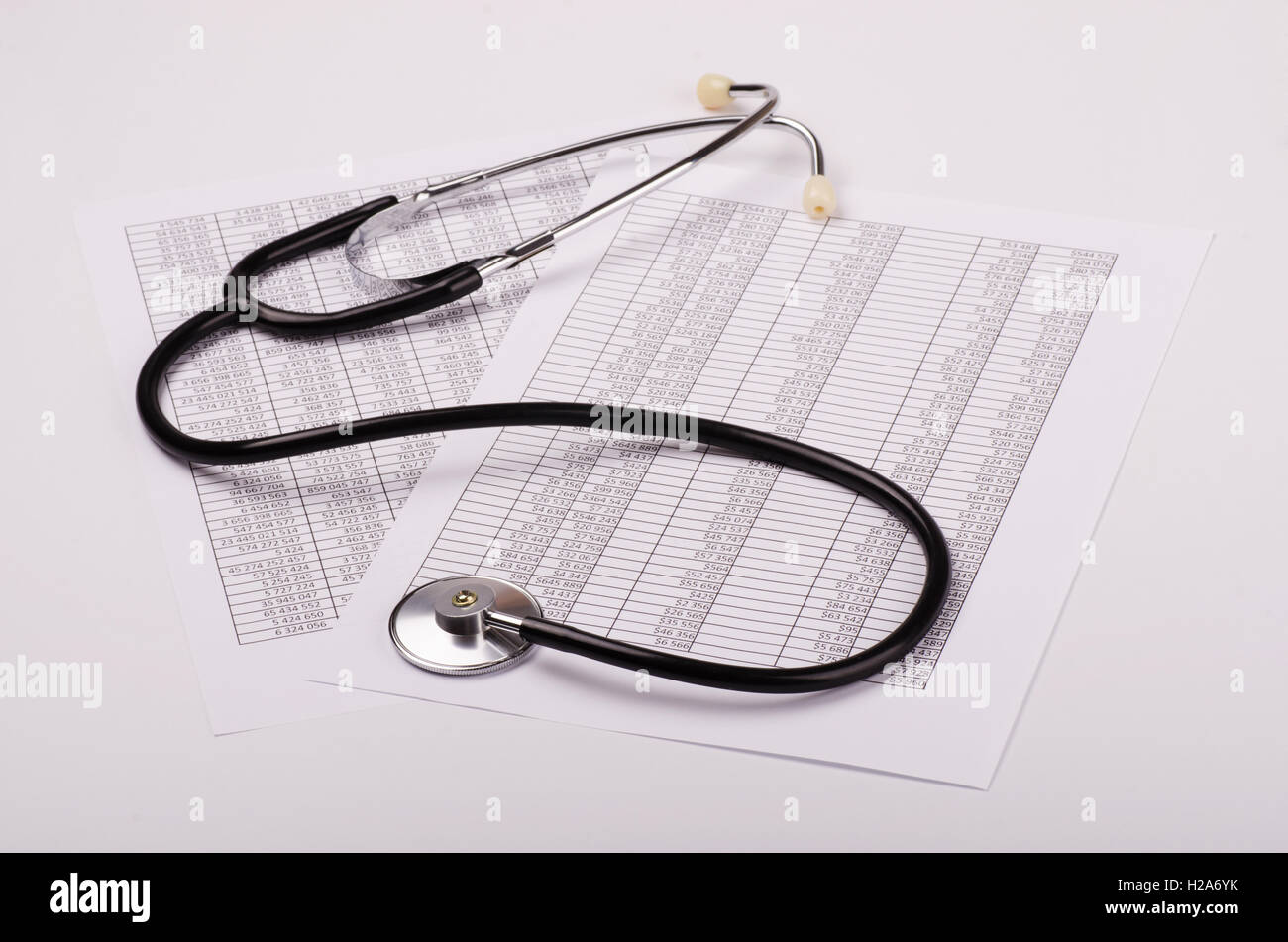 Stethoscope on financial statement on a white background Stock Photo ...