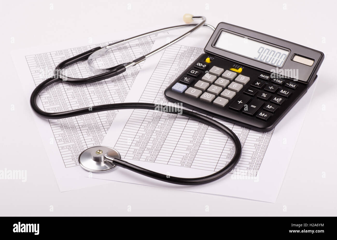 Calculator and stethoscope on financial statement Stock Photo - Alamy