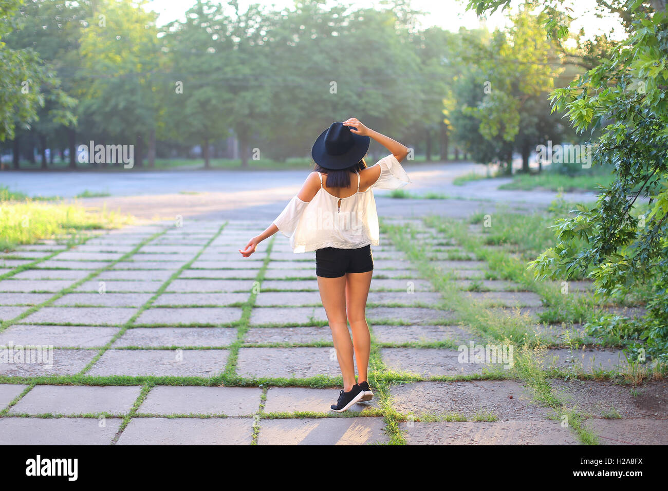 female nature keeps his hat summer sun sunset looks pleased. azitka ...