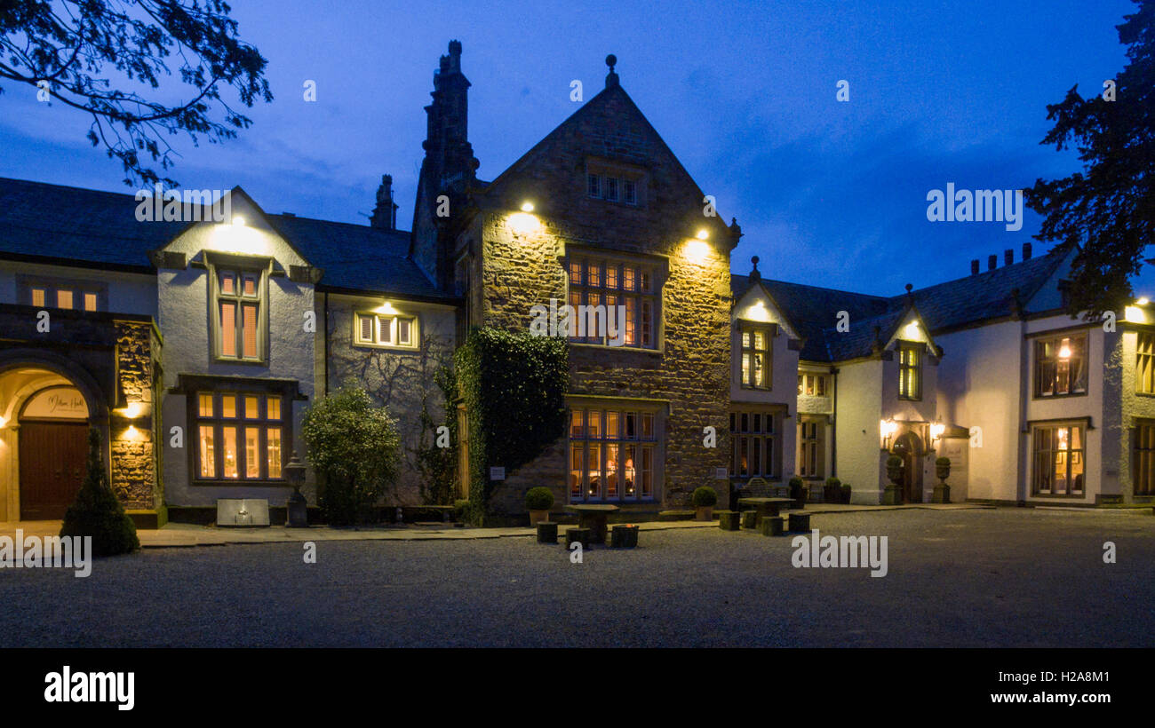 Early evening front elevation view of a floodlit Mitton Hall Hotel ...