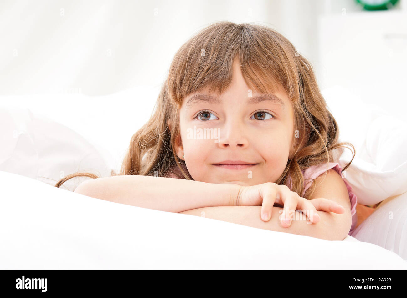 Girl awaked up in bed Stock Photo - Alamy