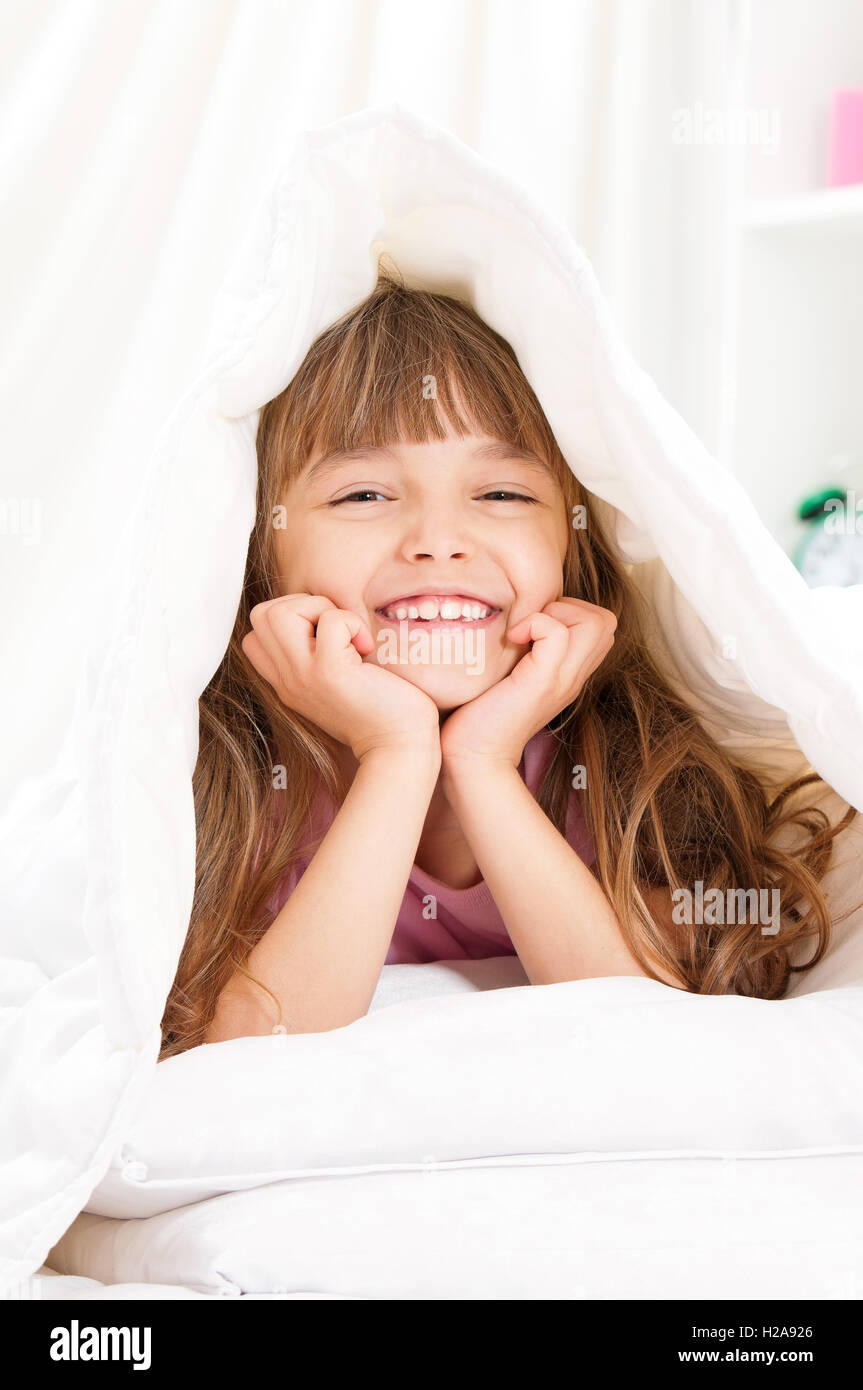Girl awaked up in bed Stock Photo - Alamy
