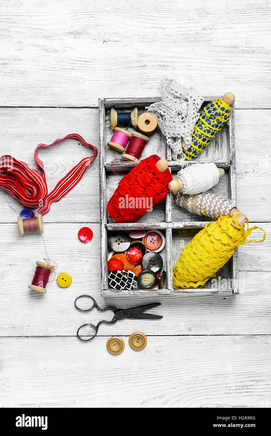 Wooden box with sewing thread,buttons and lace Stock Photo - Alamy