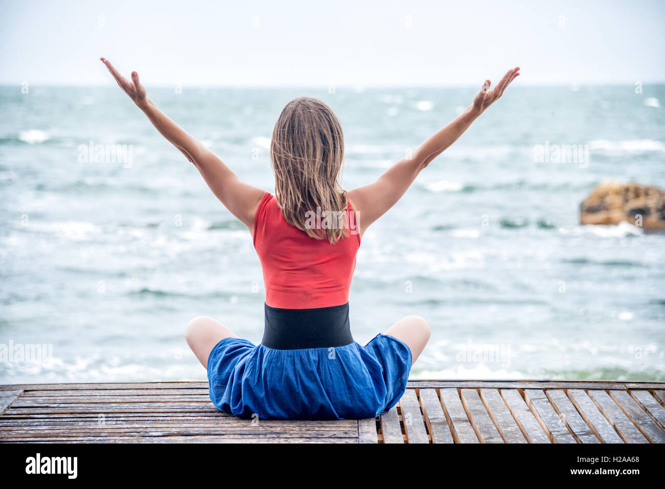 Woman meditating at the sea Stock Photo - Alamy