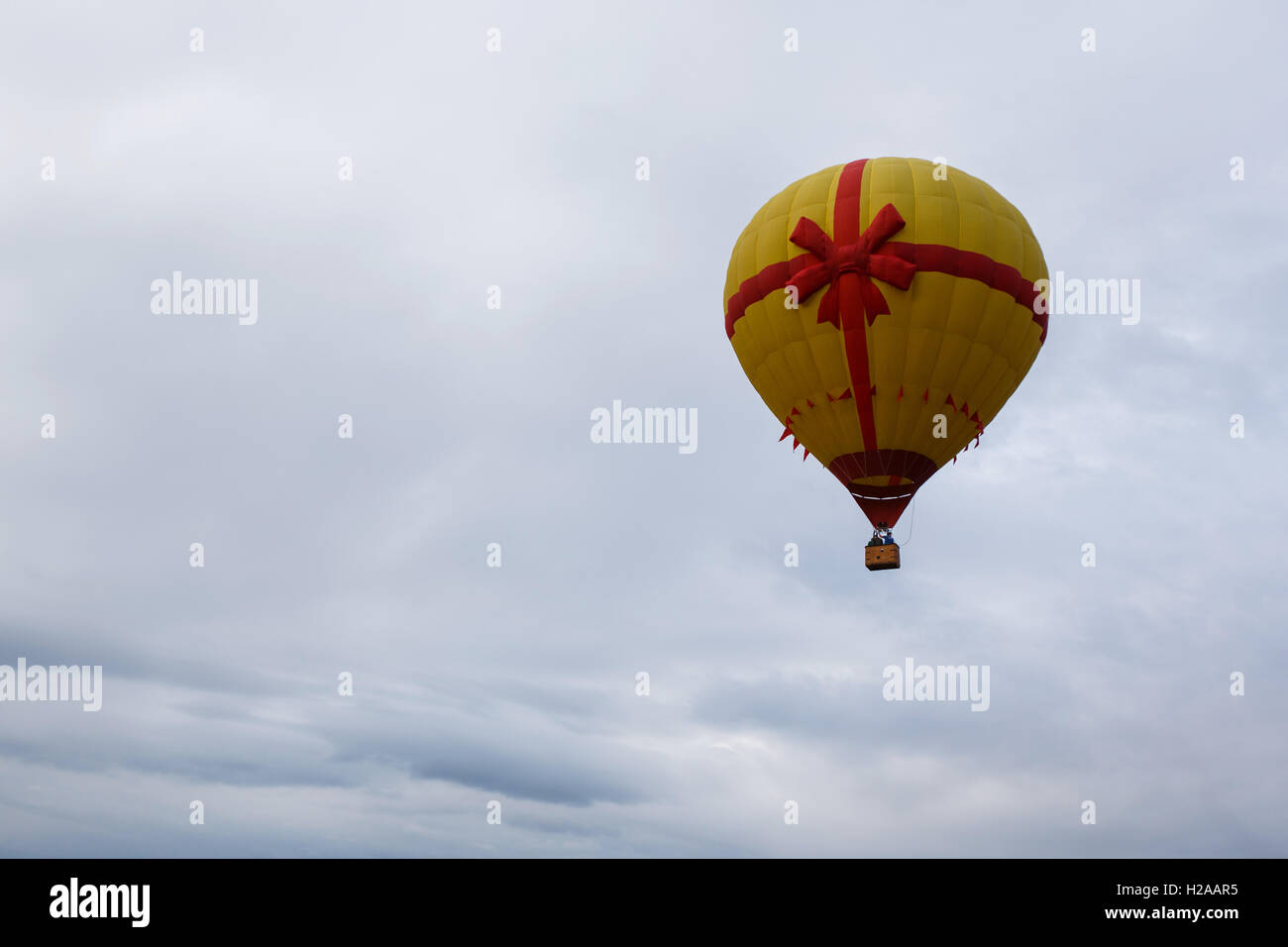 Yellow hot air balloon flying in the sky Stock Photo - Alamy