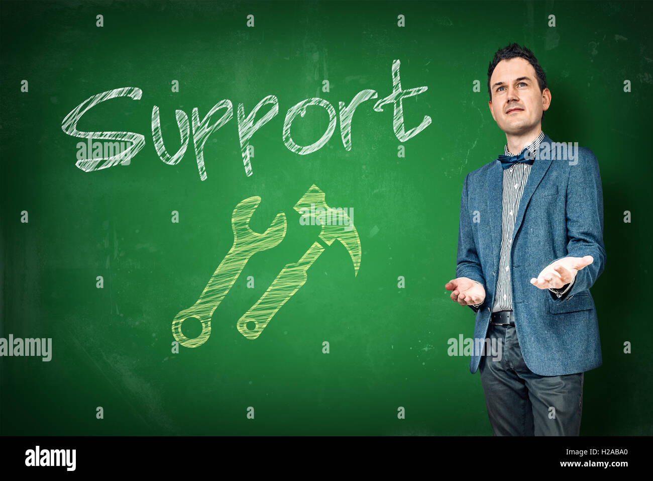 Support employee in a jacket by a chalkboard Stock Photo - Alamy
