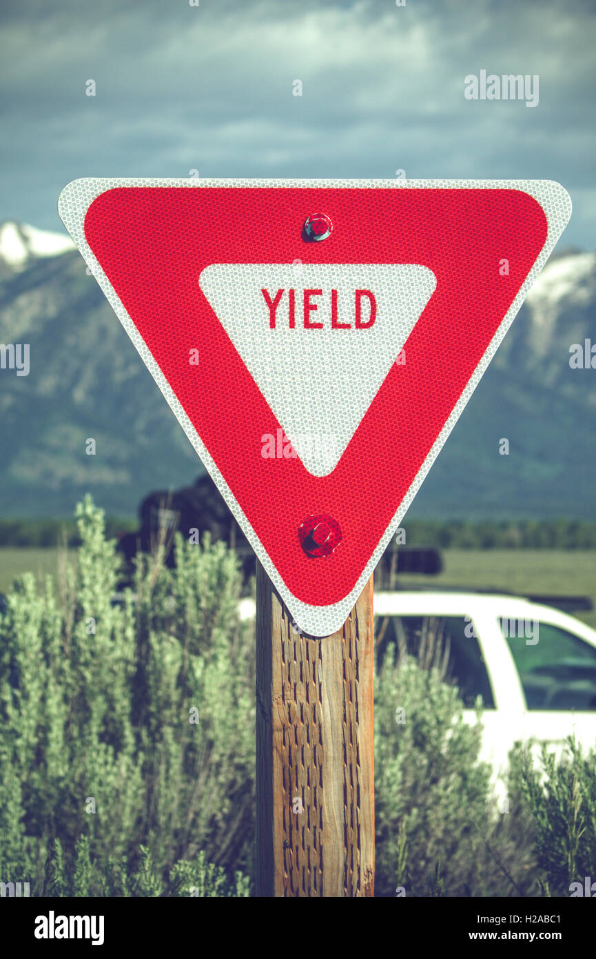 Large red yield sign in a countryside with mountains Stock Photo - Alamy