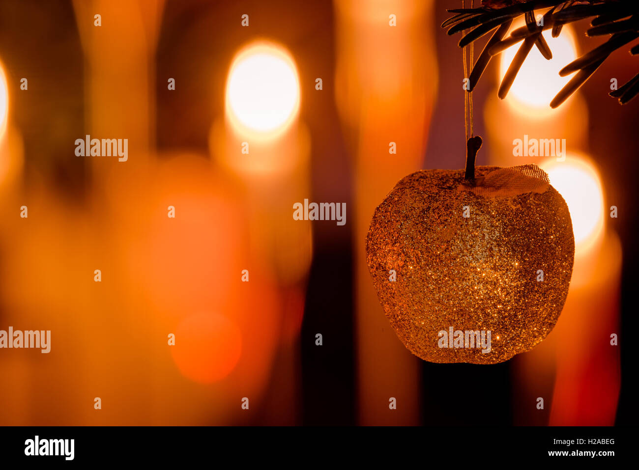 Glittering Xmas apple hanging from a branch on a tree Stock Photo - Alamy