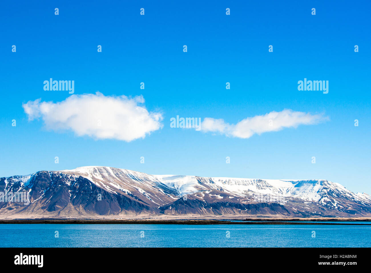 Mountains in the arctic sea with snow and blue sky Stock Photo - Alamy