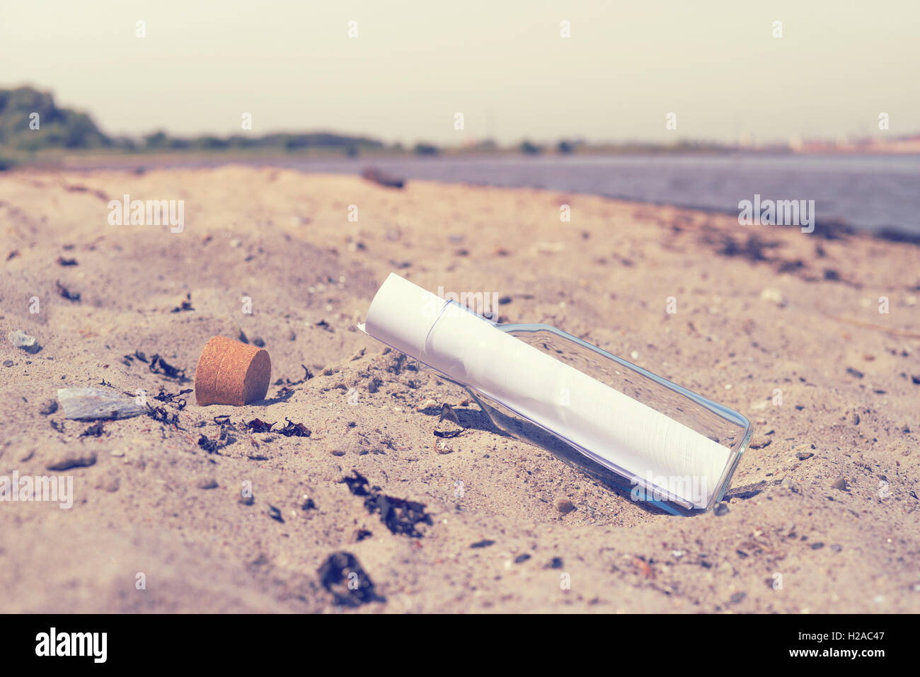 Message in a bottle on a beach in the summer Stock Photo - Alamy