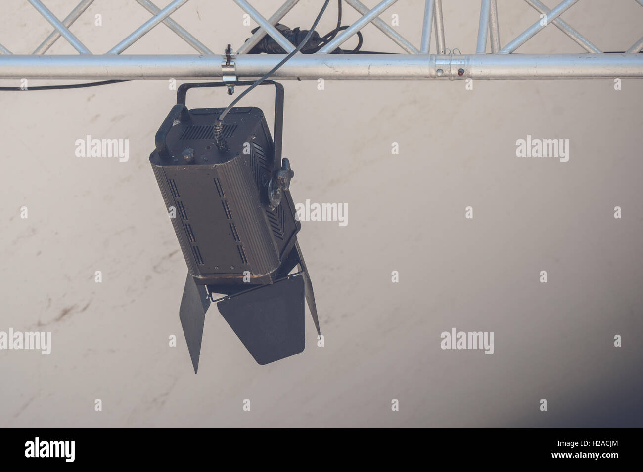 Spotlight lamp hanging on a metal stand on grey background Stock Photo ...