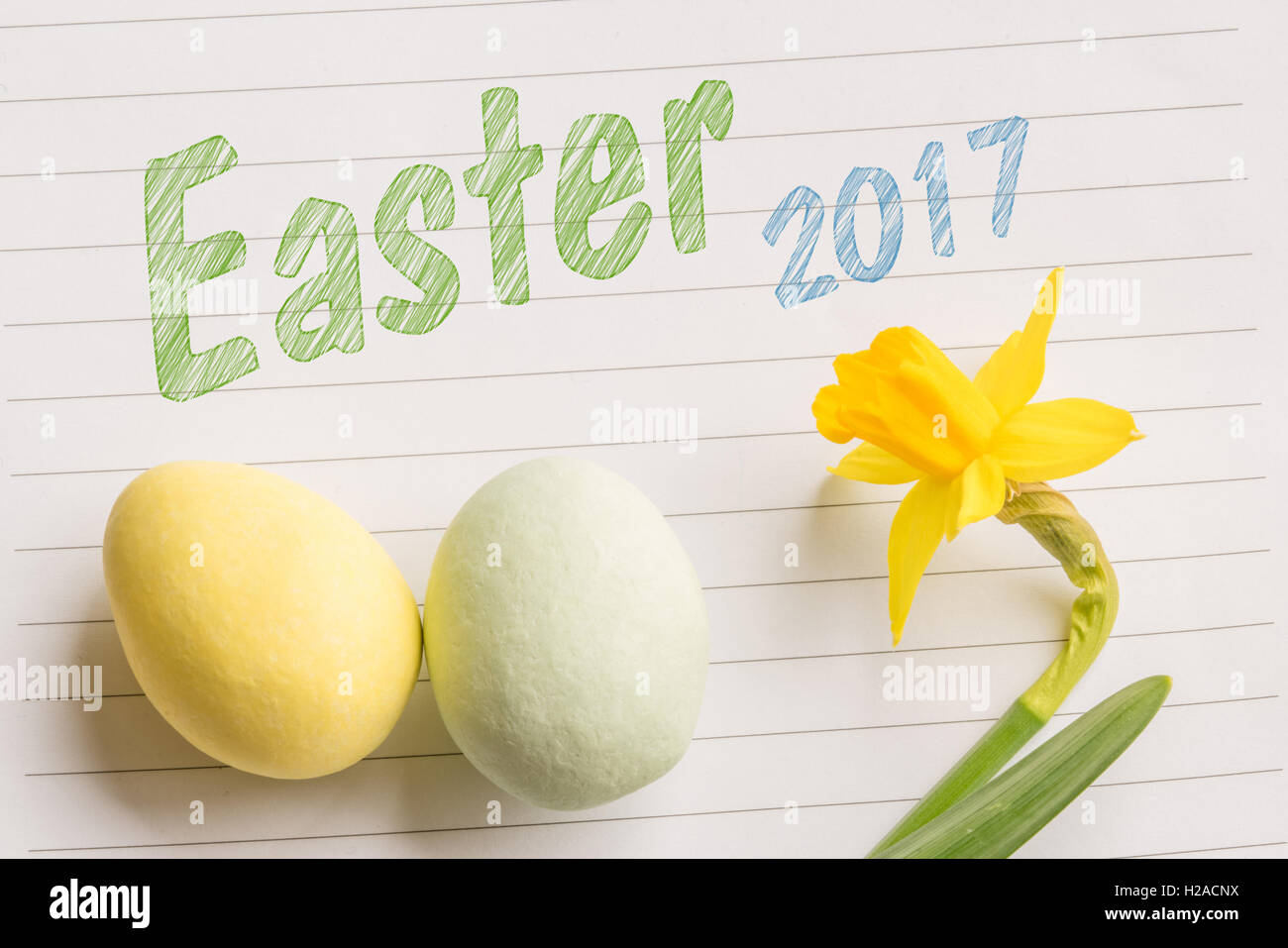 Easter 2017 greeting with daffodils and easter eggs on linear paper ...
