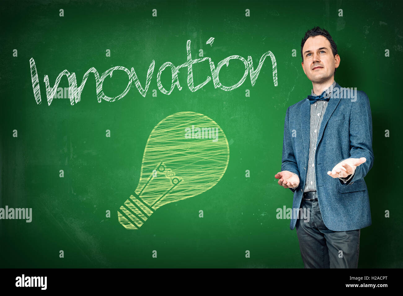 Innovation presentation on a green chalkboard by a businessman Stock ...