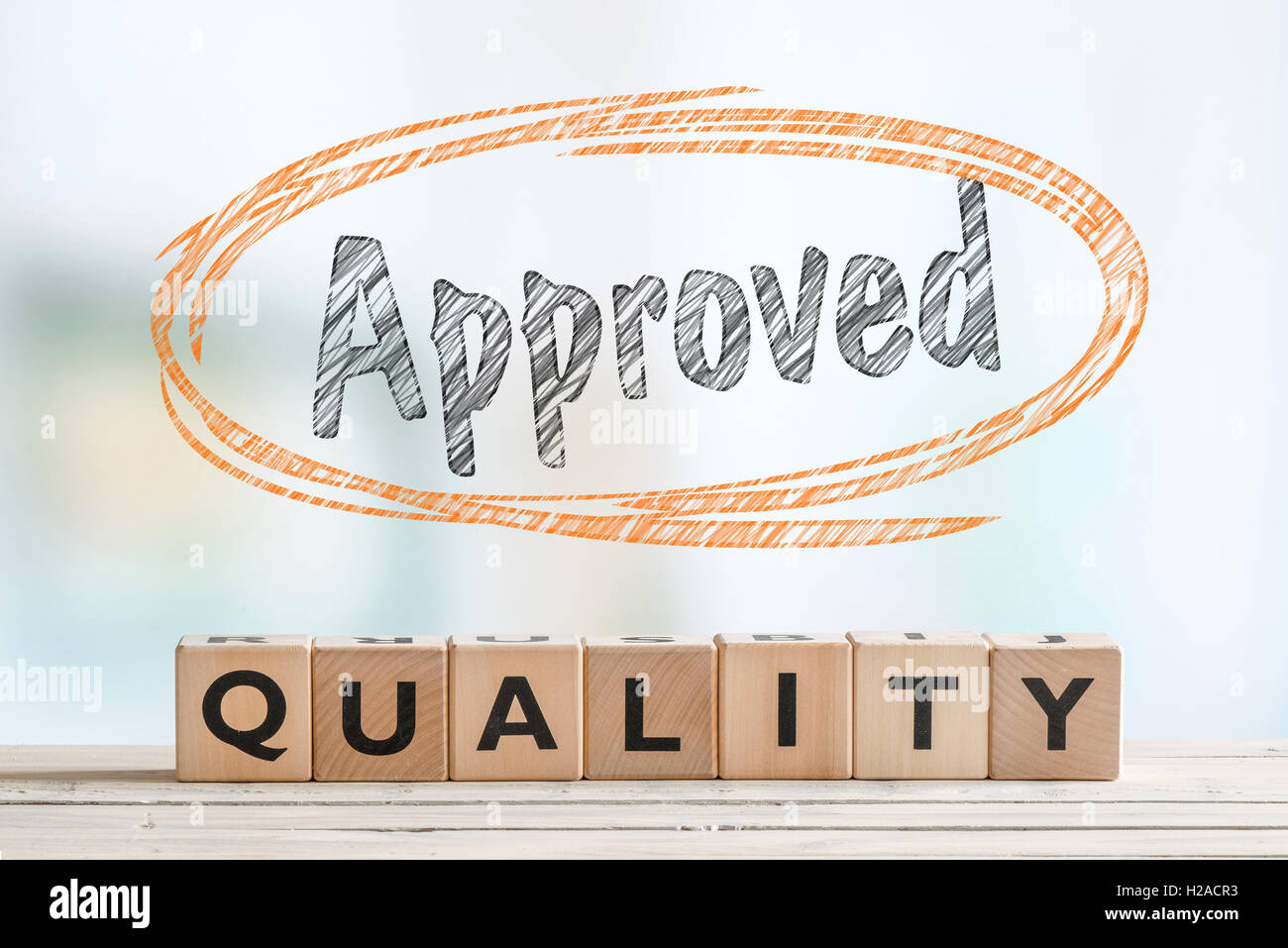 Approved quality sign on a desk in a bright room Stock Photo - Alamy