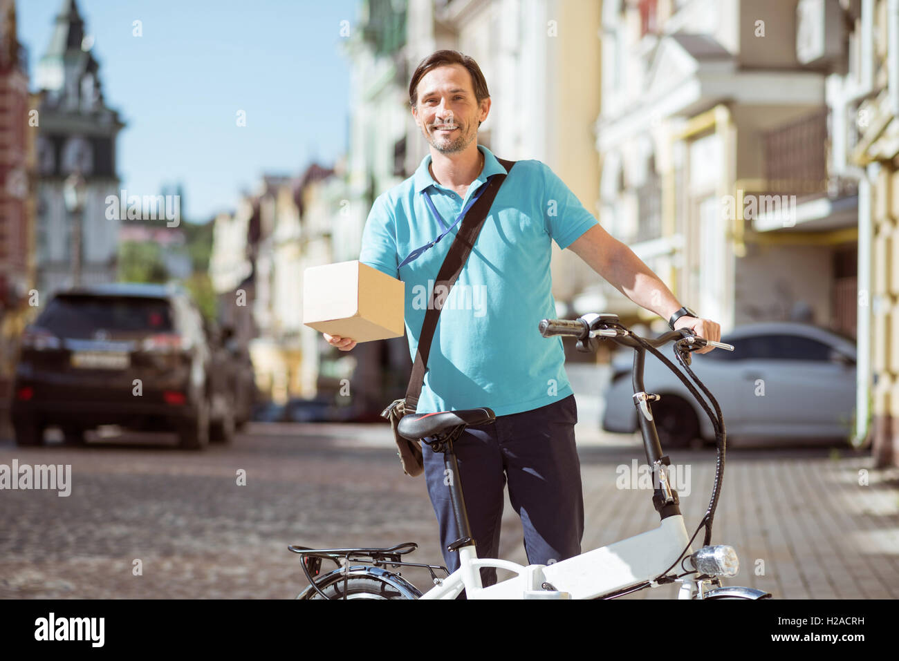 Professional smiling woman delivering the box Stock Photo - Alamy