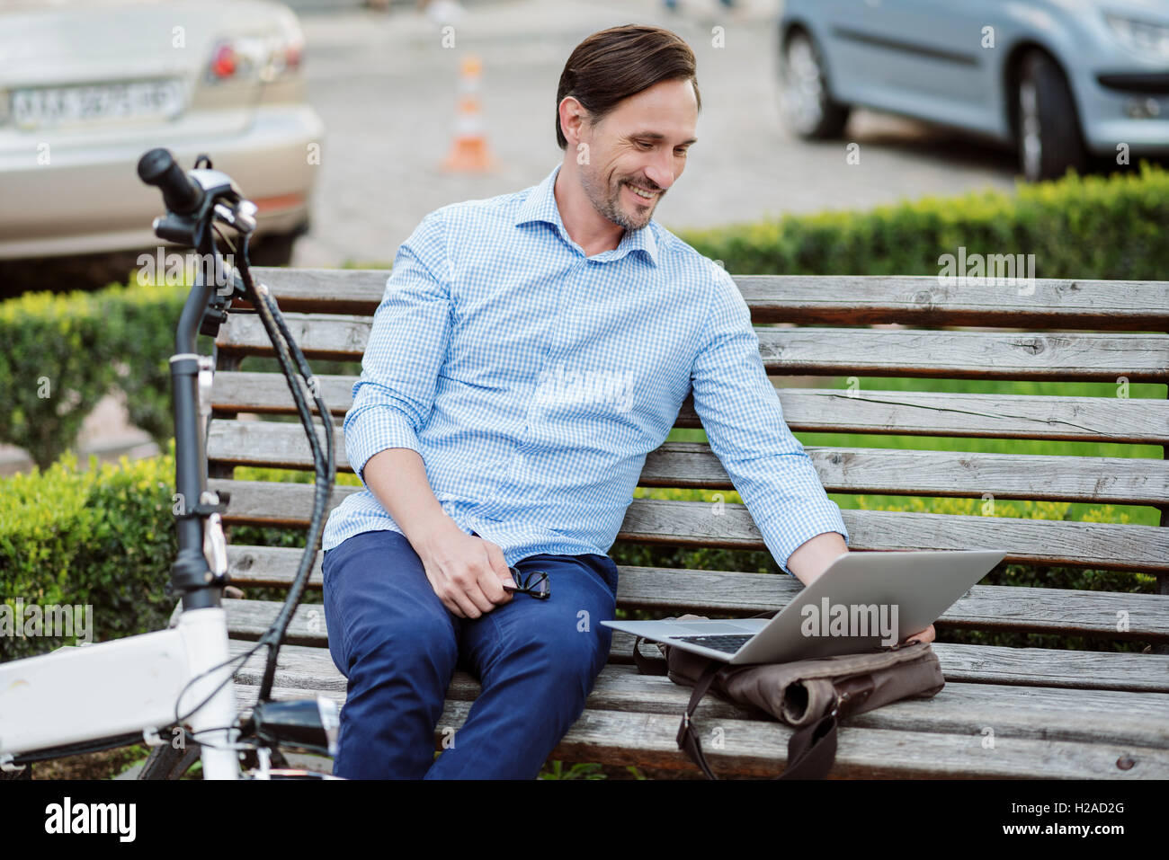 Handsome bespectacled man using laptop Stock Photo - Alamy