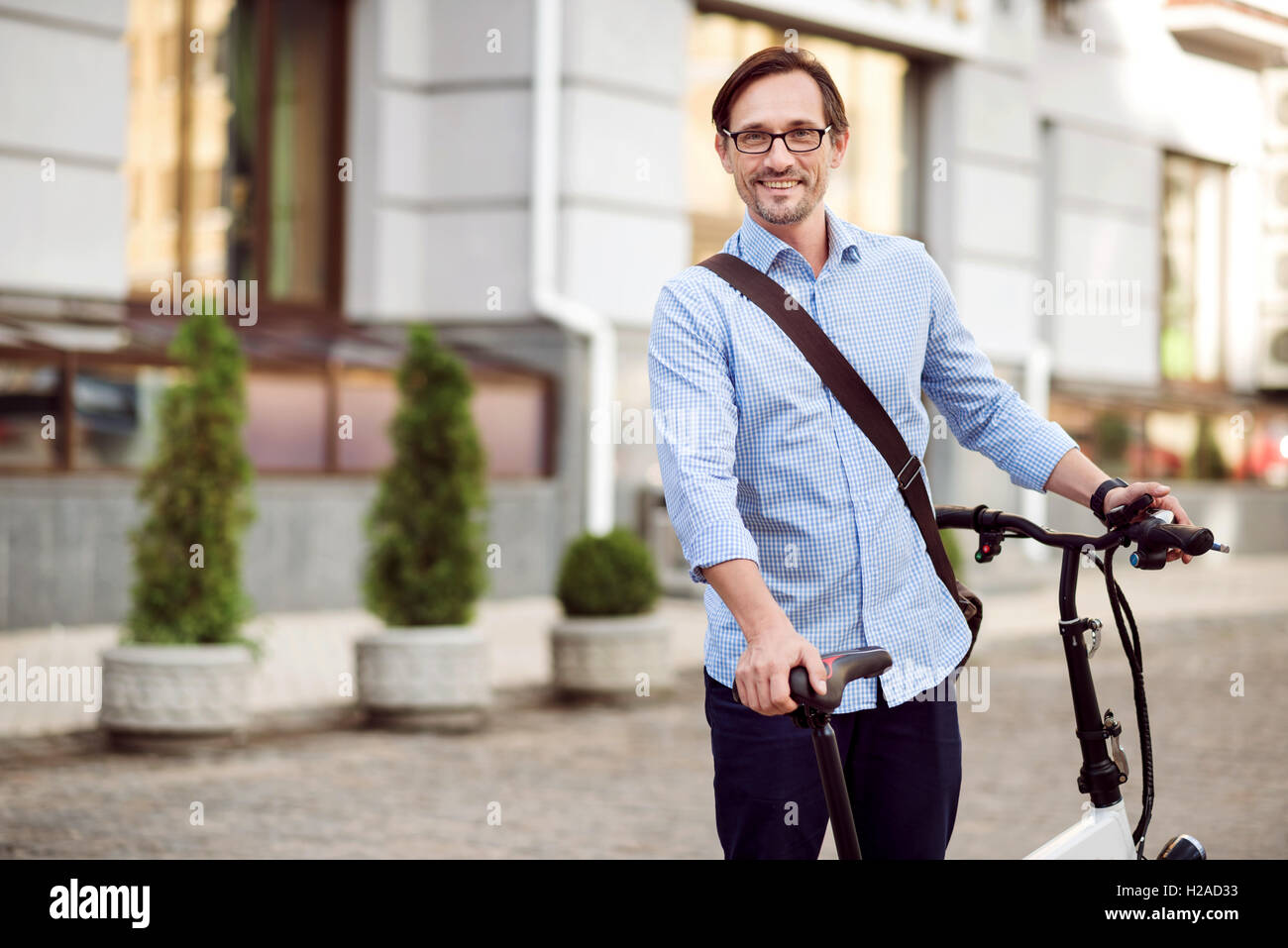 Good looking bespectacled man standing in the street Stock Photo - Alamy