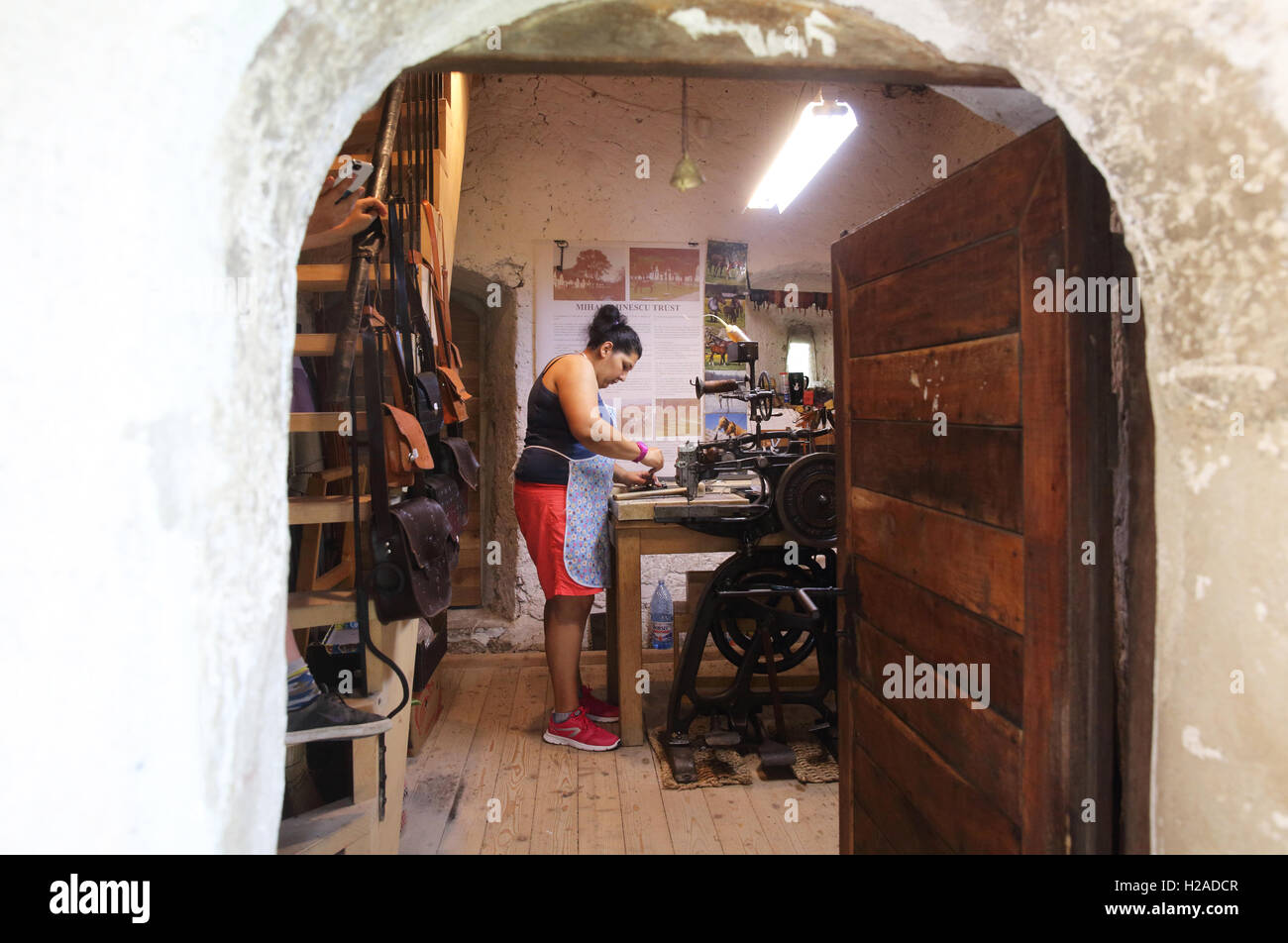 Lady making leather items to sell, in the medieval Furrier's Tower, in ...