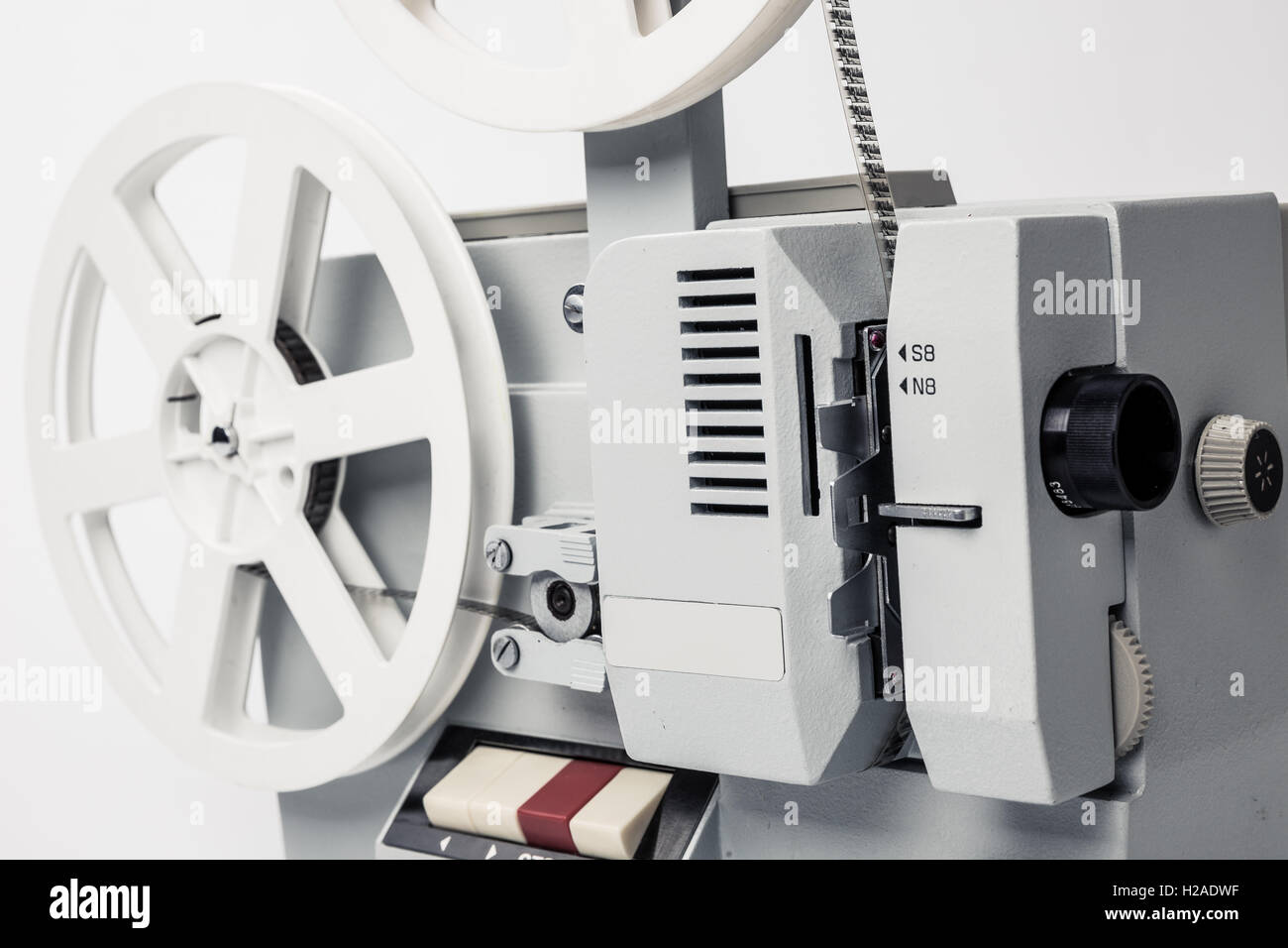 Old film projector isolated on a white background Stock Photo - Alamy