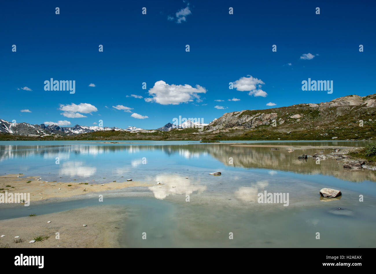 Alpine landscape, fusion lake and creek, Rutor glacier, Valle d'Aosta ...