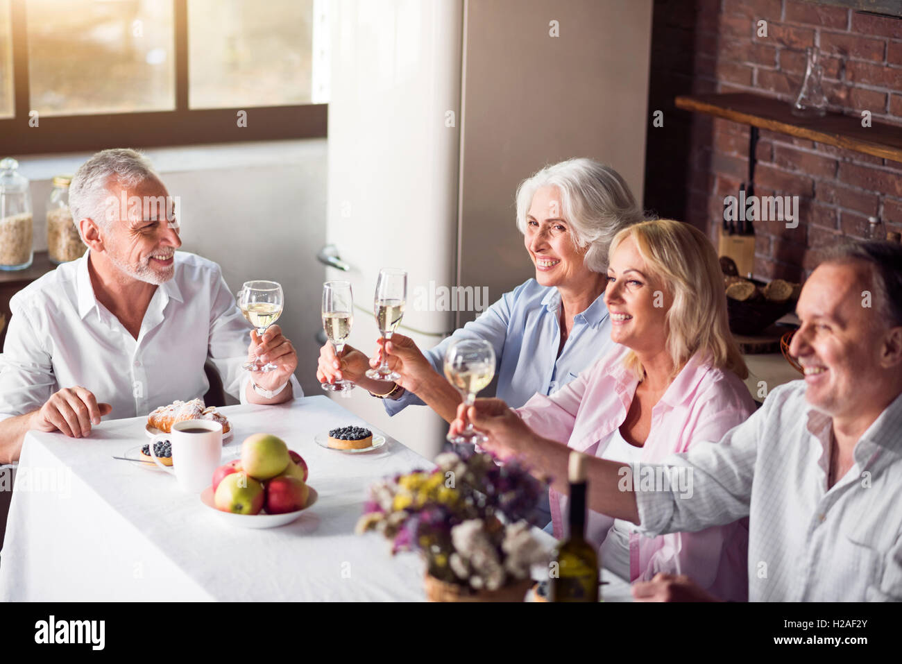 Family members sitting at table hi-res stock photography and images - Alamy