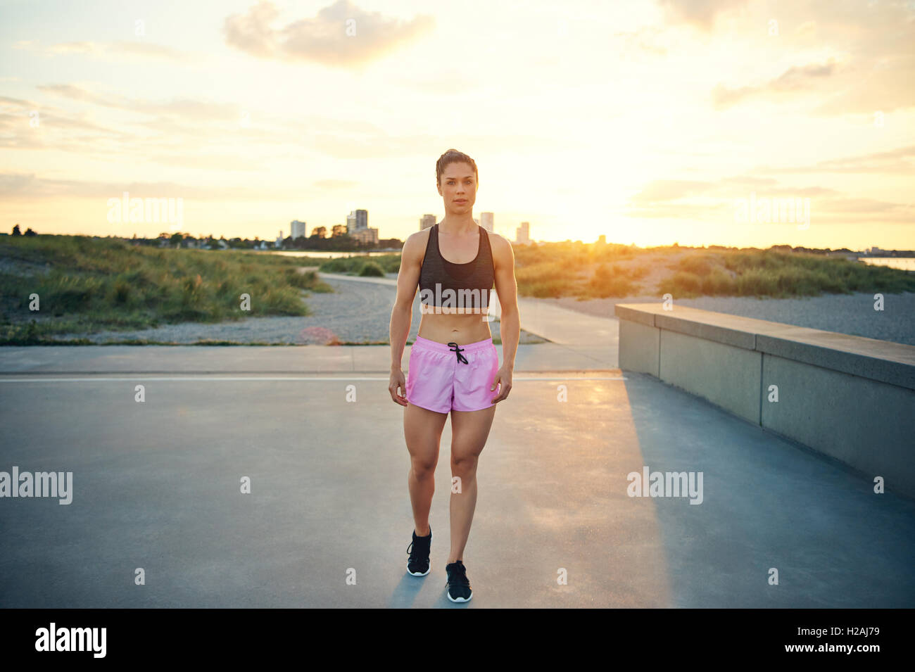 Fit healthy woman with a muscular body walking towards the camera in ...