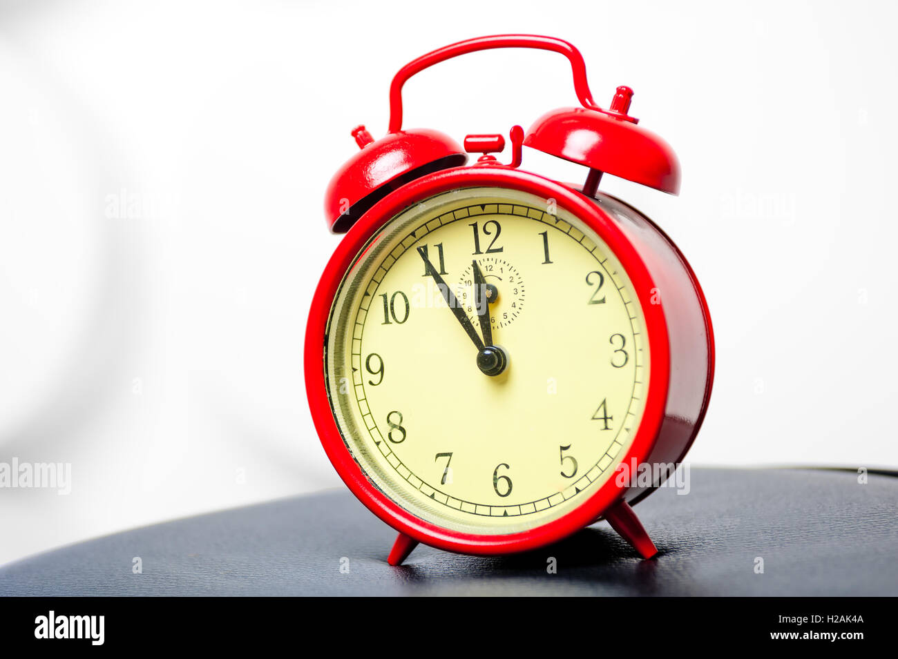 red alarm clock in a retro style shot in a studio Stock Photo - Alamy