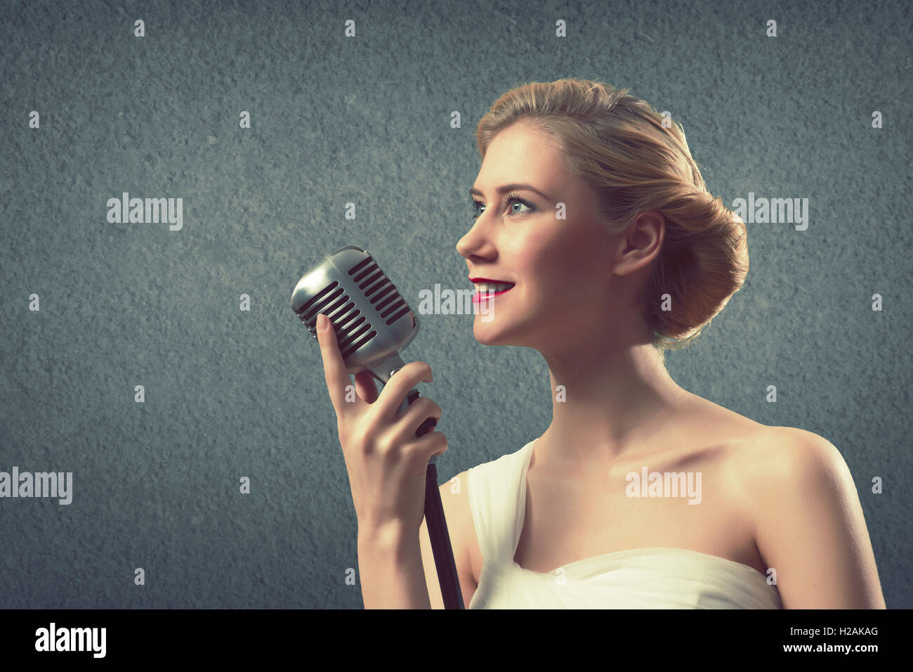 attractive female singer with microphone Stock Photo - Alamy