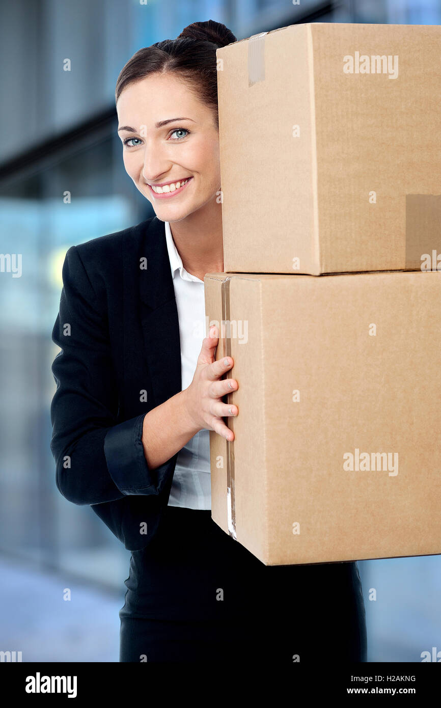 Female executive holding cardboard boxes Stock Photo - Alamy