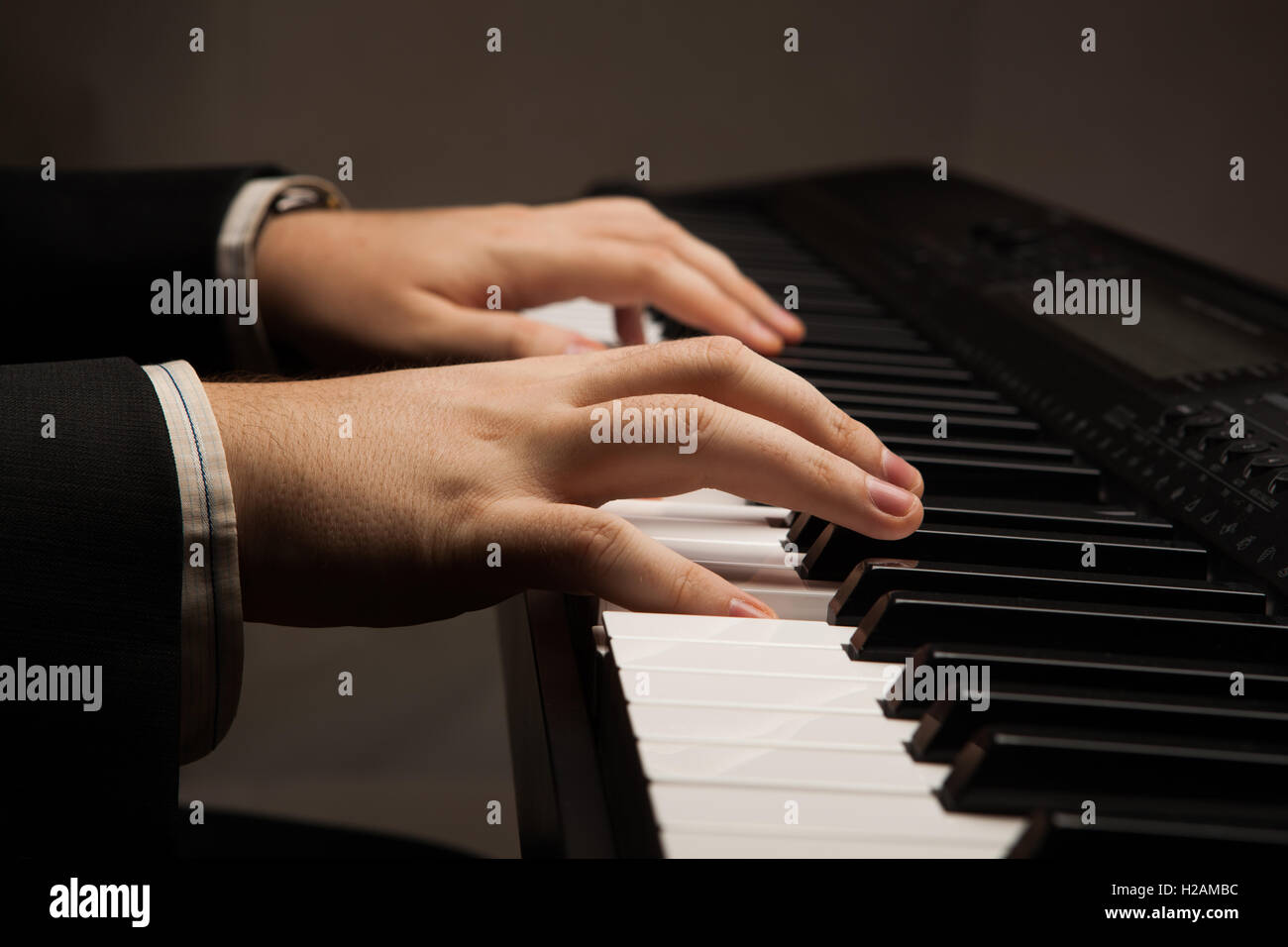Piano keys and human hands Stock Photo - Alamy