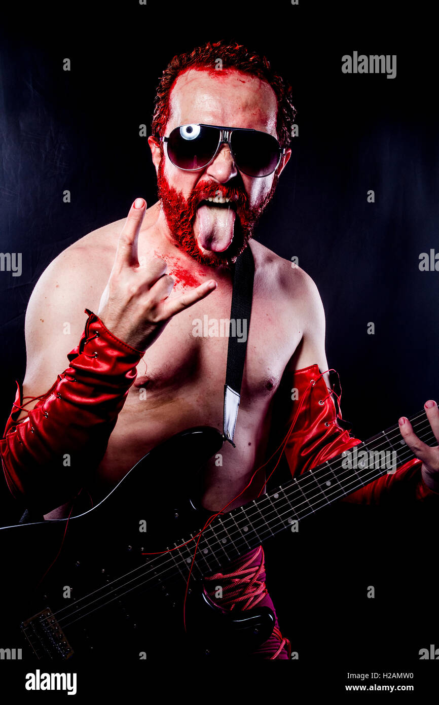 guitarist with electric guitar black, wearing face paint and red Stock ...