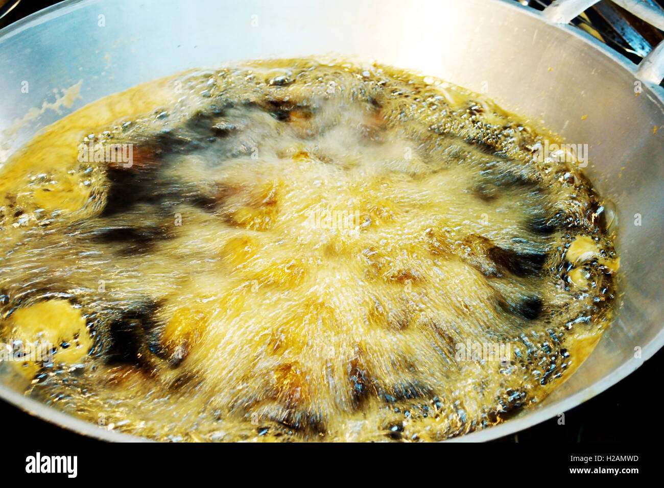Boiling oil in pan Stock Photo - Alamy