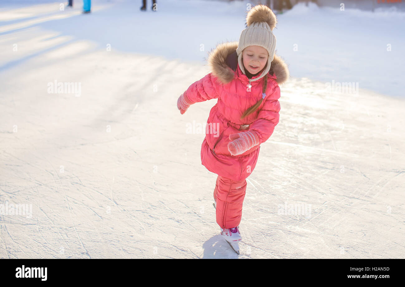 Little happy girl skating on the ice-rink Stock Photo - Alamy