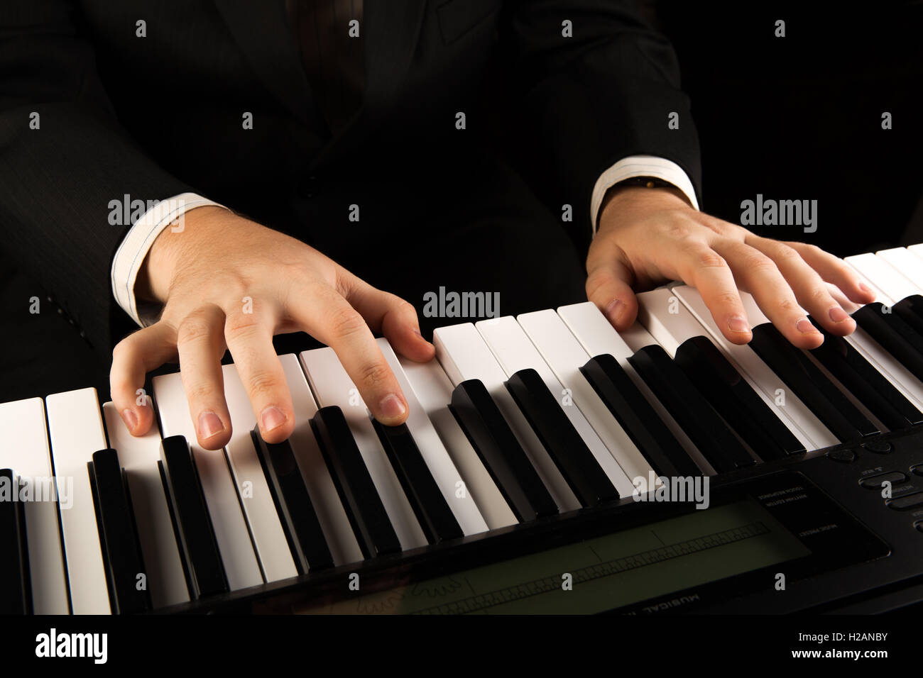 Piano keys and human hands Stock Photo - Alamy
