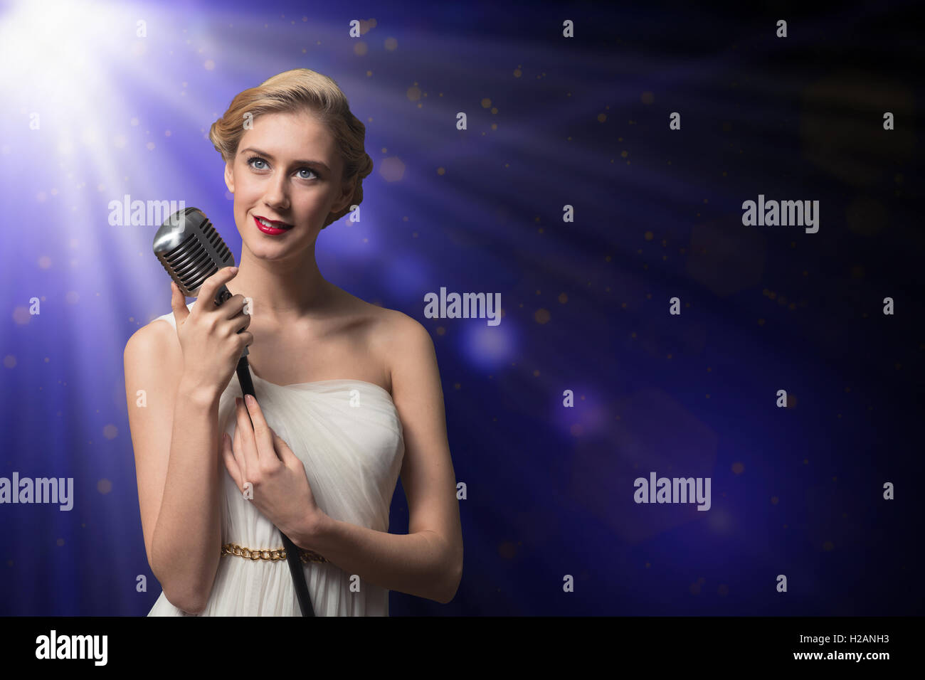 attractive female singer with microphone Stock Photo - Alamy