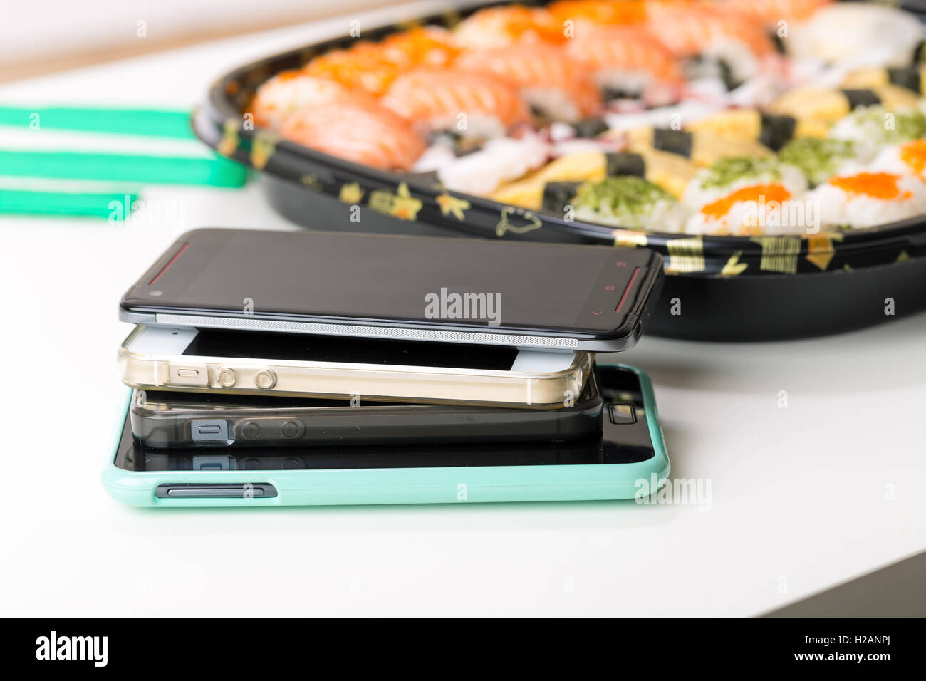 Mobile phones and sushi Stock Photo - Alamy