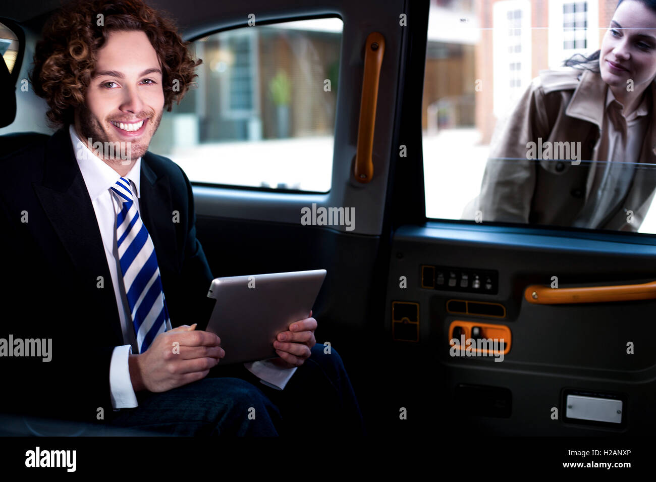 Smart young businessman, inside taxi cab Stock Photo - Alamy
