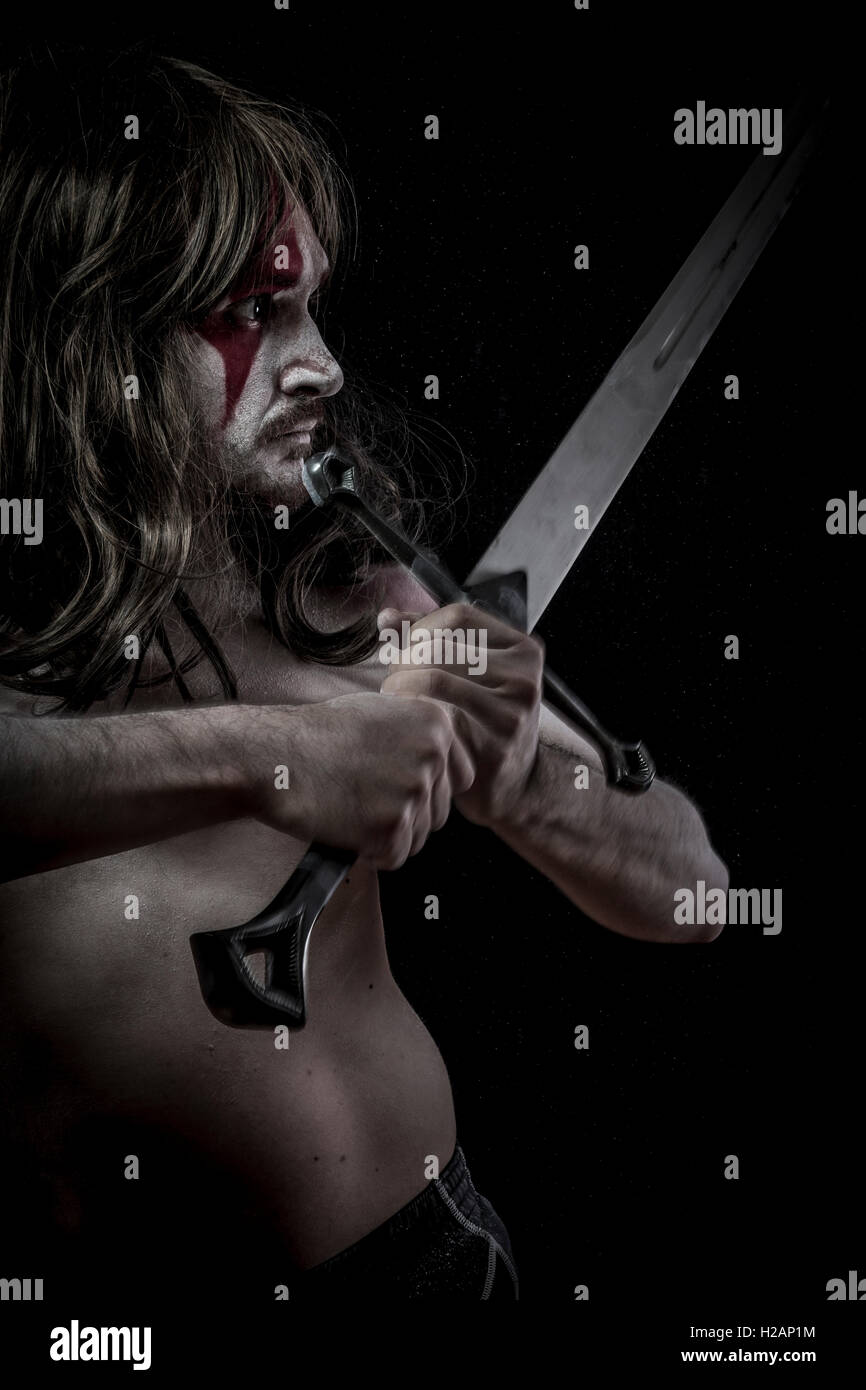 Medieval savage warrior with iron sword Stock Photo - Alamy