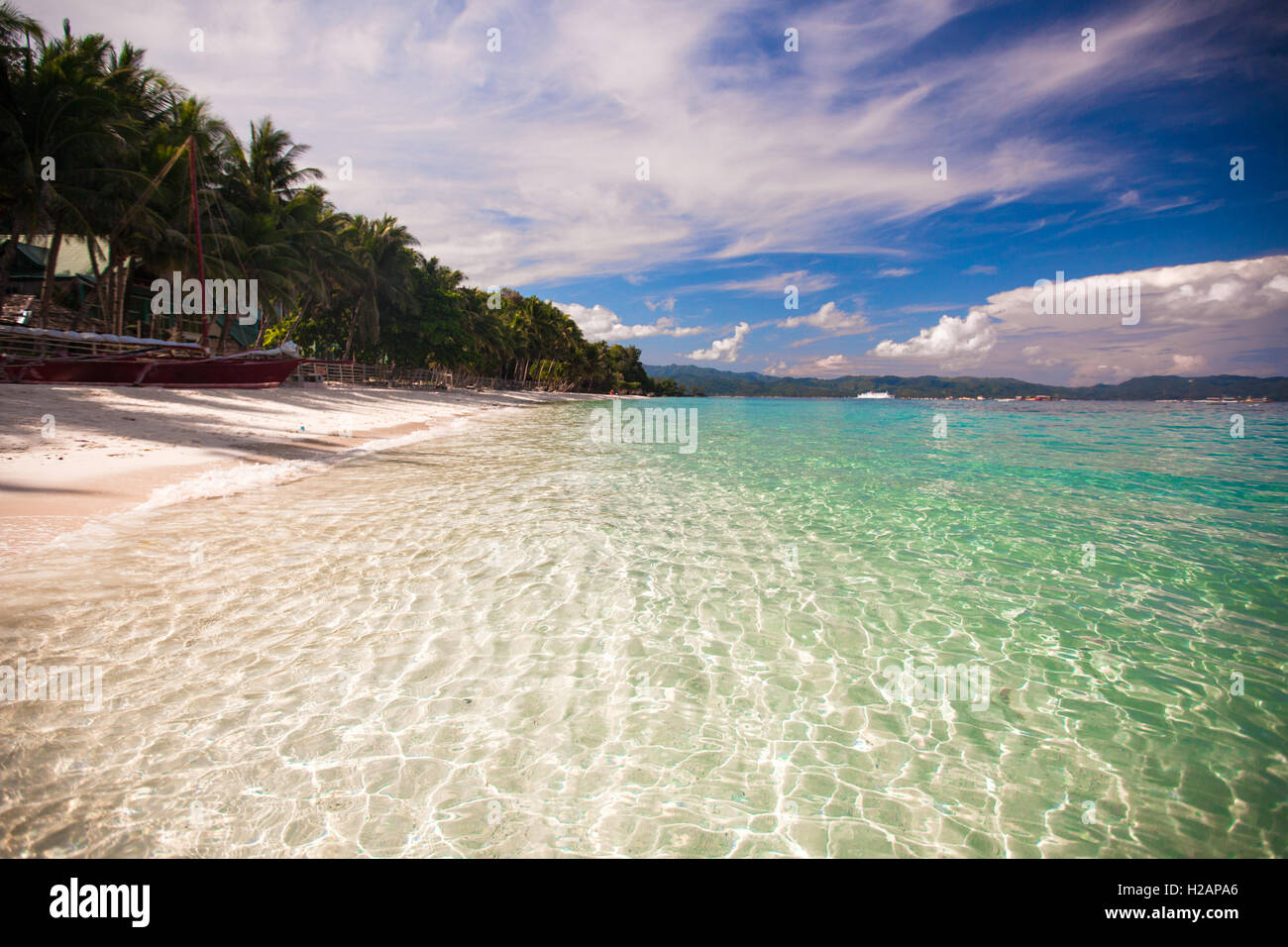Tropical beach with white sand and a small boat Stock Photo - Alamy
