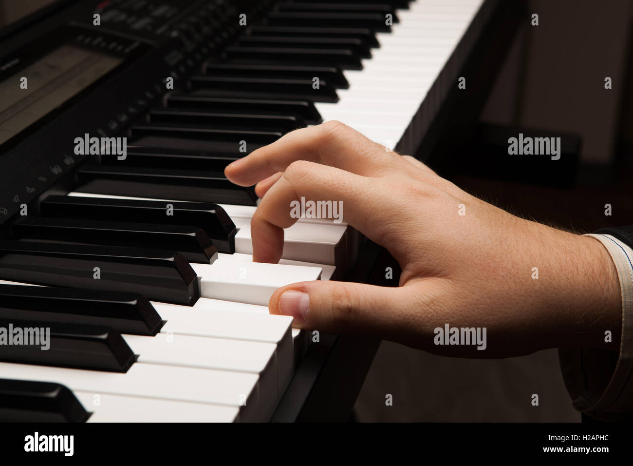 Piano keys and human hand Stock Photo - Alamy