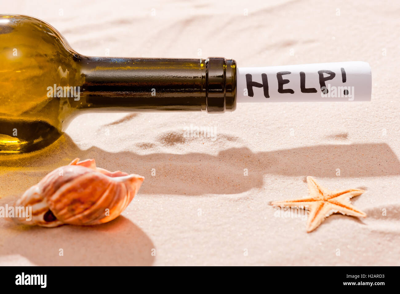 bottle requesting assistance and seashells on the beach Stock Photo - Alamy